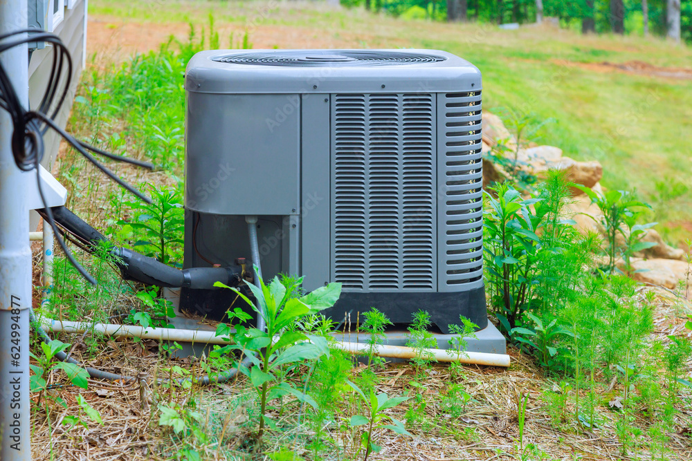 Installed on exterior concrete foundation of house is unit for outside ...