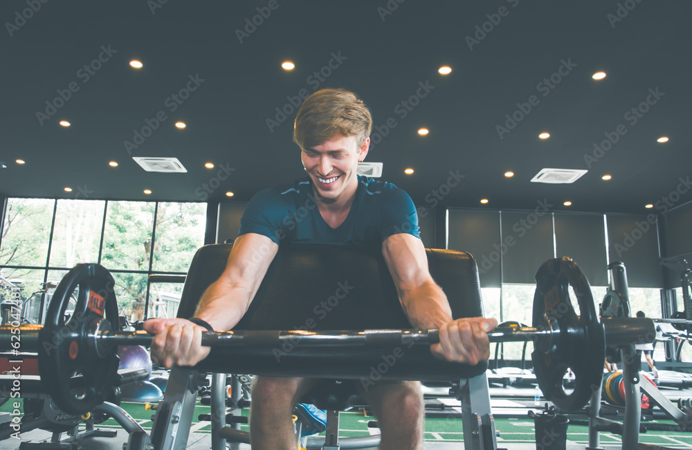 Handsome male athlete with barbell exercise in fitness gym, during ...