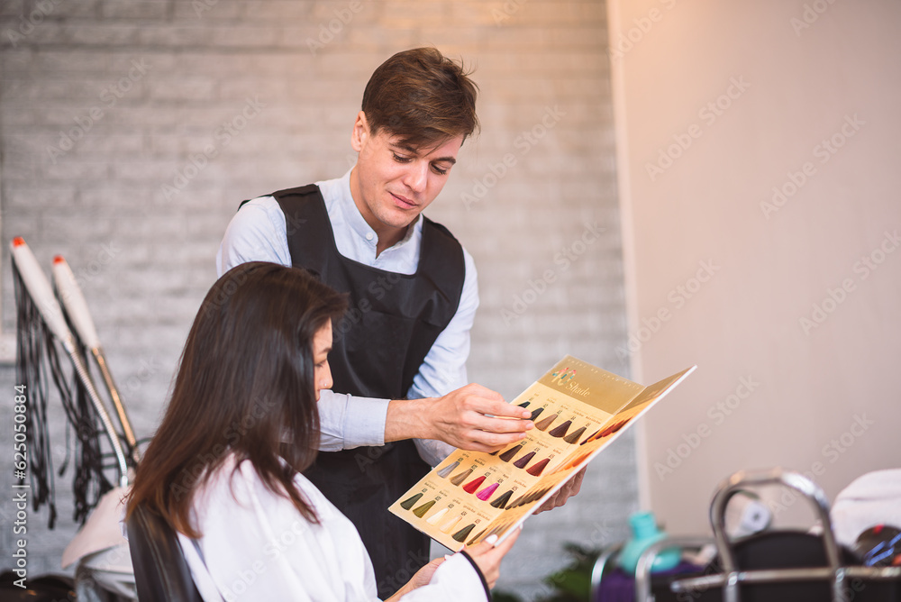 Hairdresser man giving advice to beautiful woman customer choosing new ...