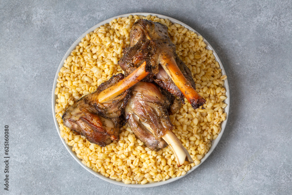 Turkish foods; lamb shank tandoori on bulgur wheat rice (Turkish name ...