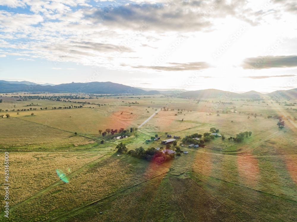 Australian farm aerial landscape with sun light rays over house ...