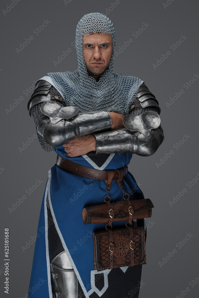 Brave royal guard dressed in medieval armor and blue surcoat, with ...