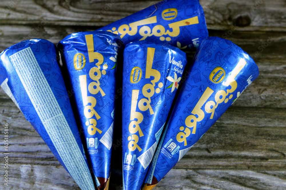 Cairo, Egypt, July 15 2023: Kimo Kono Nestle vanilla ice cream cone topped with caramel, nuts ...