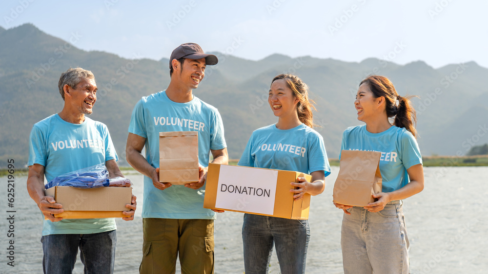 group of diverse volunteer carrying donation box raising money ...