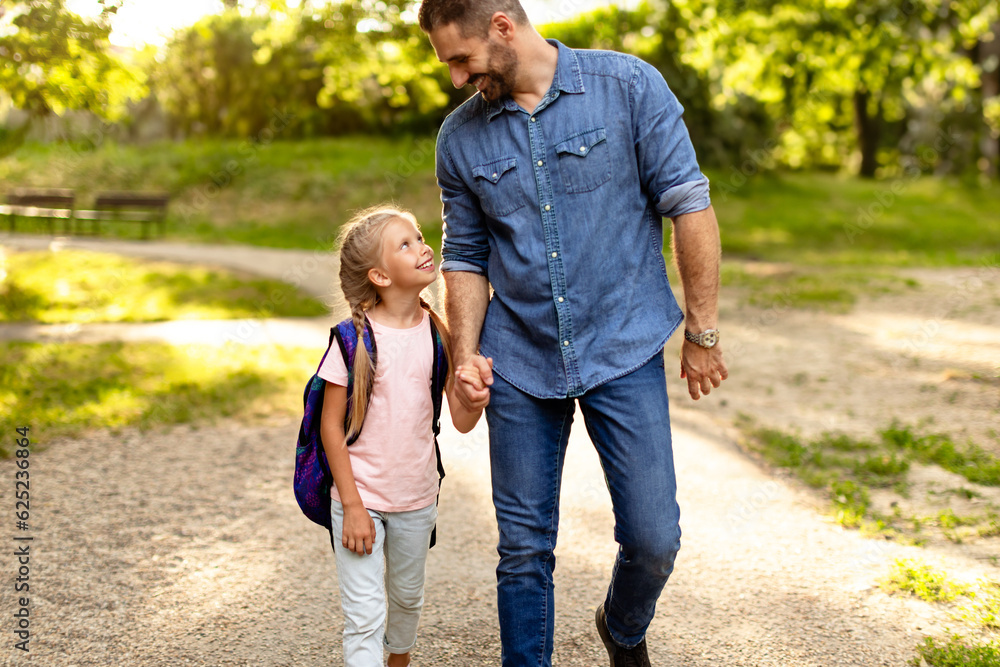 First day at school. Happy father leading his little child school girl ...