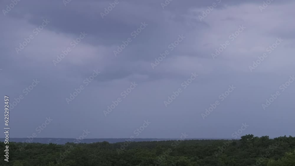 Lightning flash in storm clouds. Heavy clouds bring multiple flashes of ...