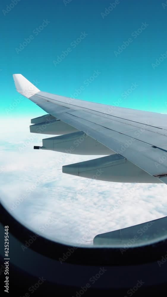 Airplane flight. Wing of an airplane flying above the clouds. . Side ...