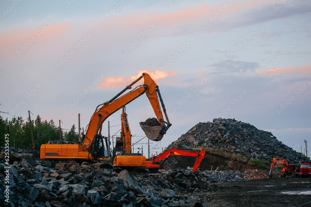 Excavators working on earthmoving at open pit mine in mining and ...