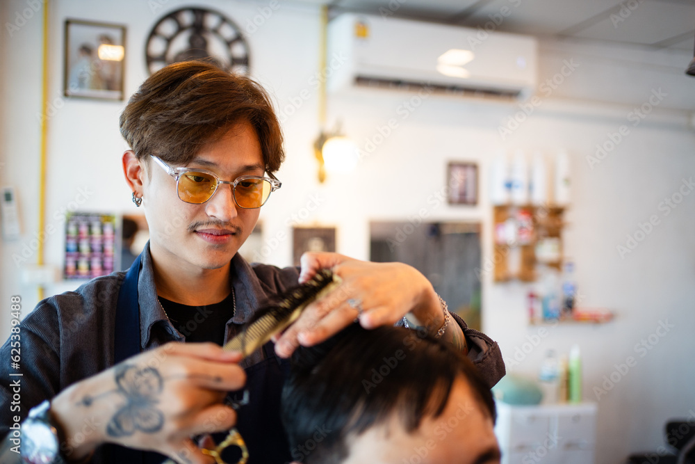 Handsome Asian man having a haircut at street hairdresser shop ...