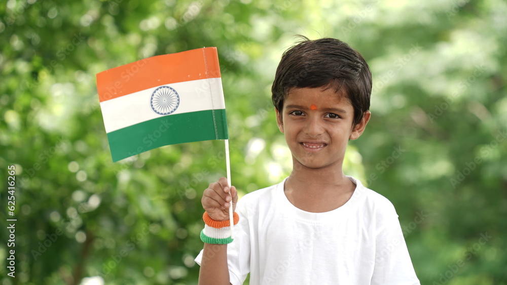 Cute little boy holding Indian flag in his hands and smiling ...