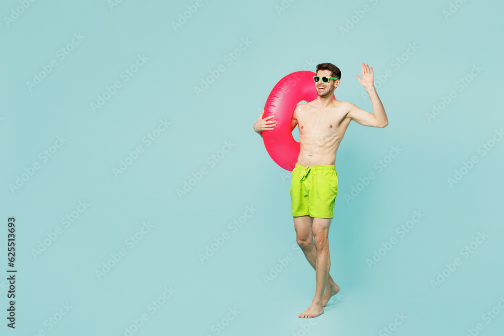Full body young man wears green shorts swimsuit glasses relax near ...