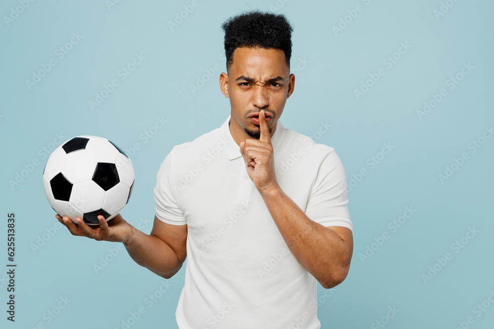 Young man fan in t-shirt say hush be quiet with finger on lips shhh ...