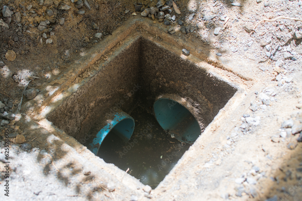 installing concrete manhole with drain pipes at construction site Stock ...