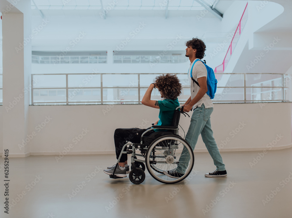 African American student pushing his friend's wheelchair through a ...