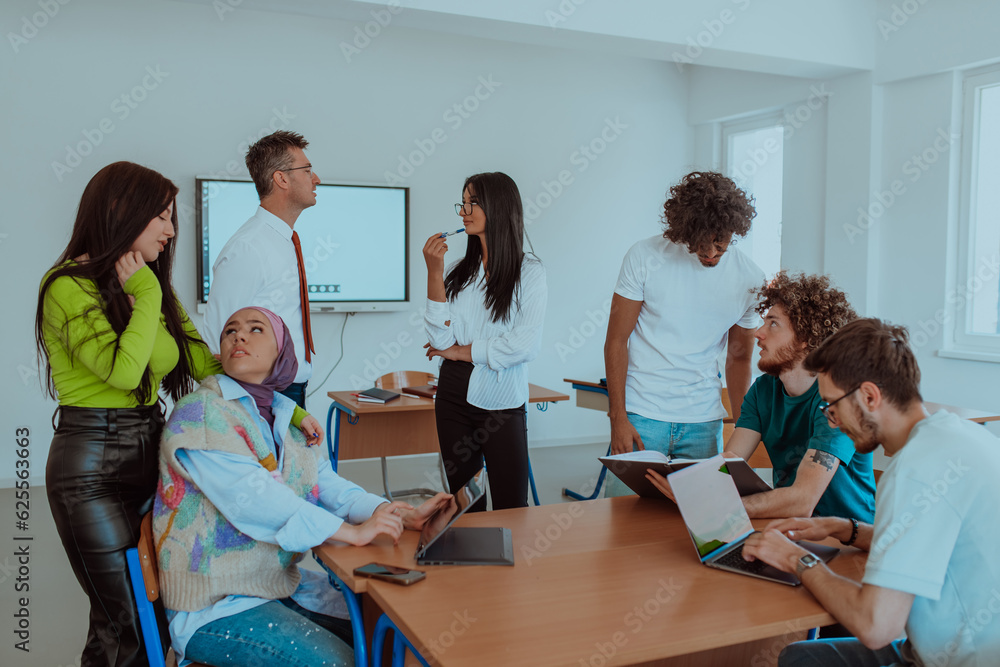 A diverse group of students gathers in a modern school classroom ...