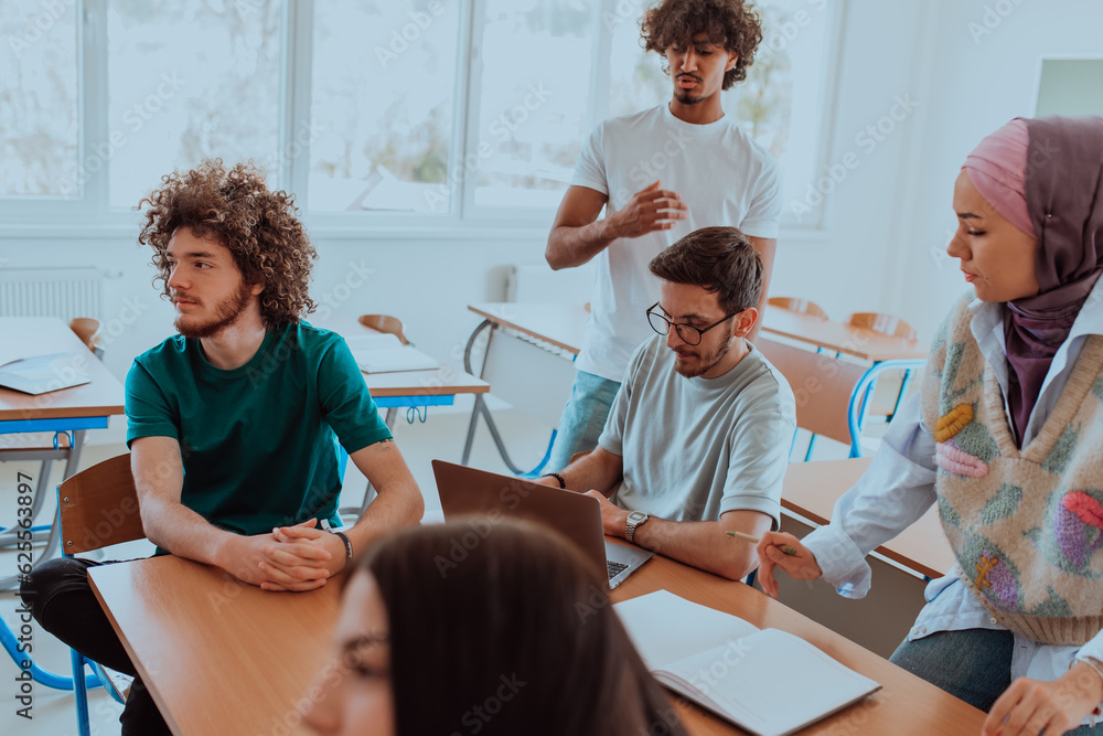 A diverse group of students gathers in a modern school classroom ...