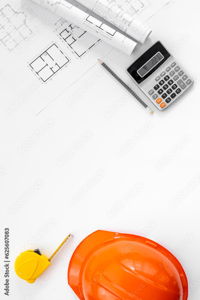 Construction helmet on drawing blueprints for house designing and ...