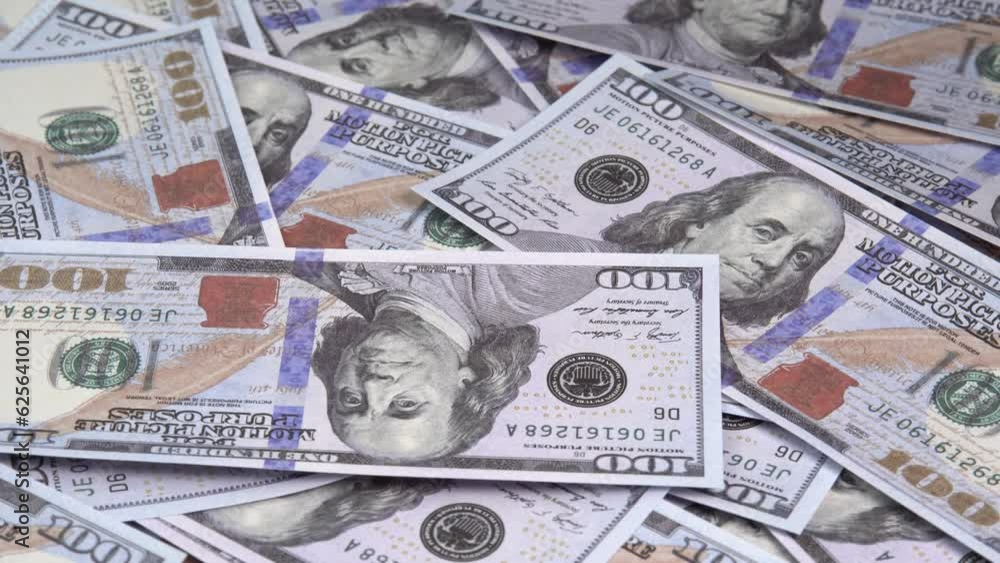 Fake US dollars rotating as background. Counterfeiters check banknotes ...