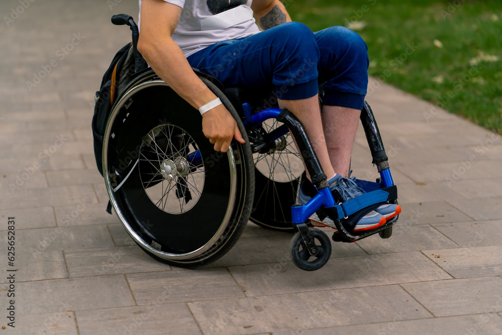 Inclusiveness Portrait of a young man with a disability in a wheelchair ...
