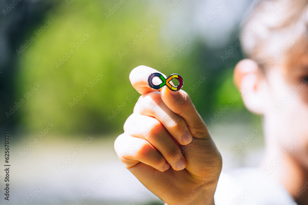 Autism infinity rainbow symbol sign in kid hand. World autism awareness ...