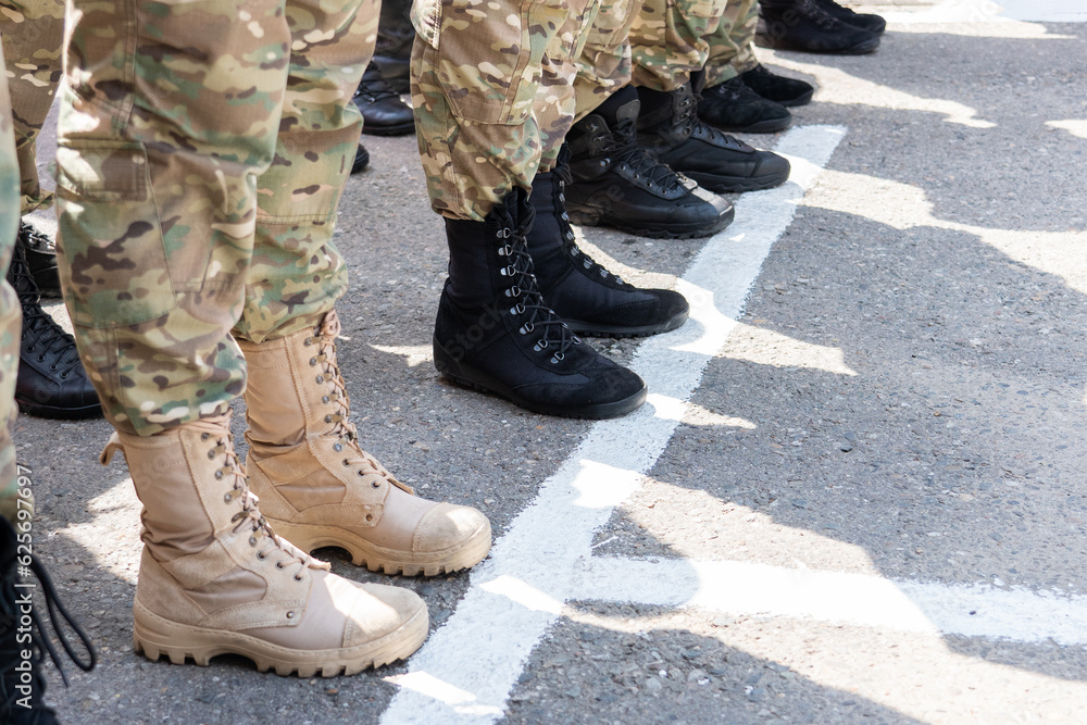 The soldiers are in line. Military uniform and footwear. The legs of ...