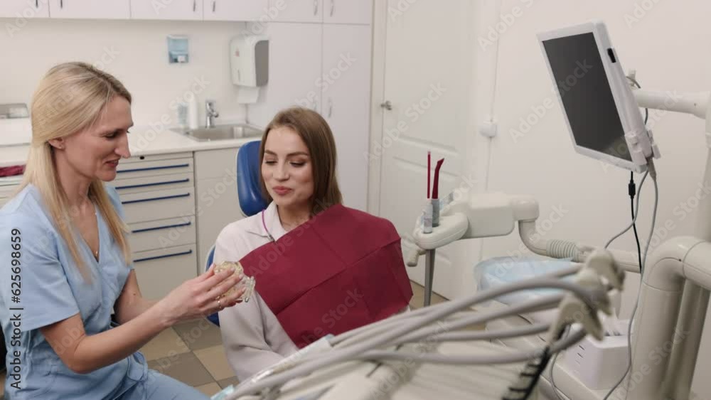 Dental teeth, Jaw model, Patient guidance. Female patient focuses on ...