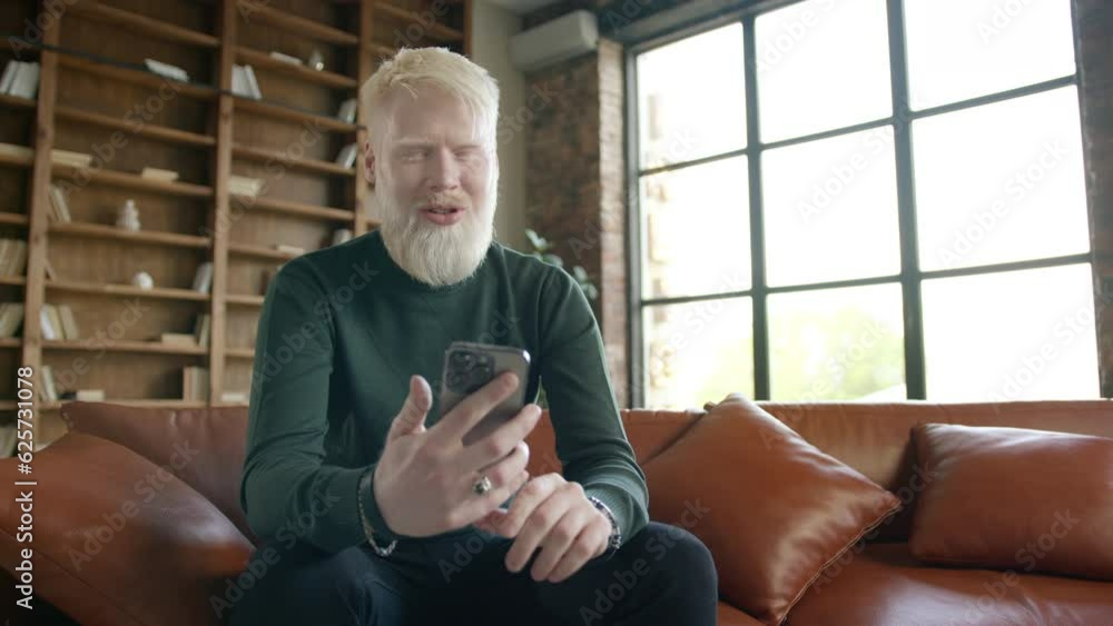 Discolored white haired man with albinisms disease causing neurological ...