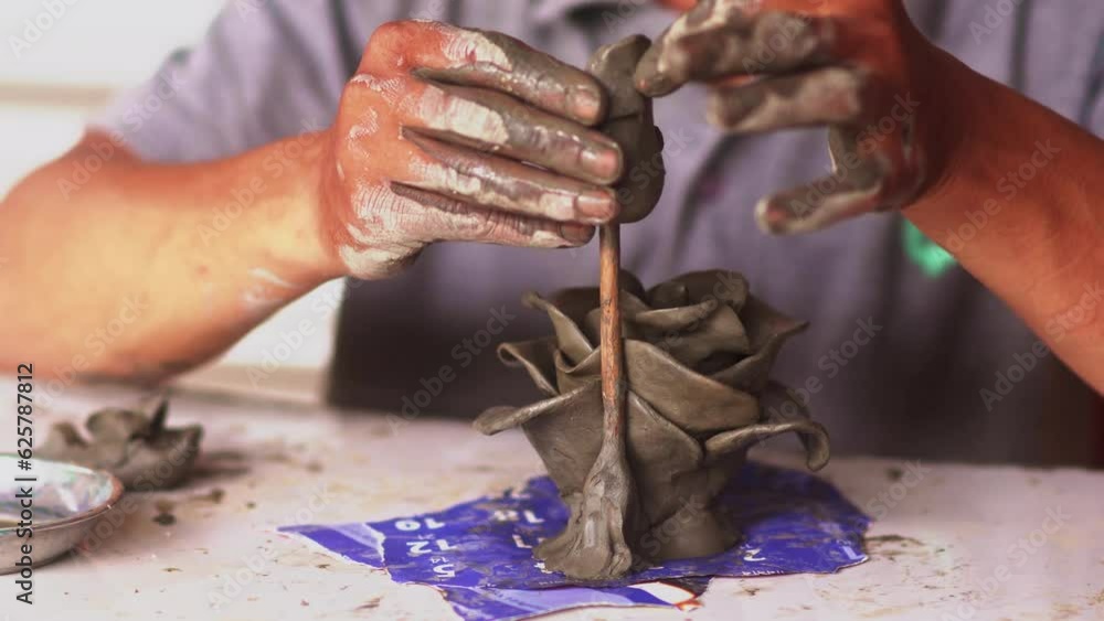 Sculptor man creating sculpture from clay in workshop. Process of ...