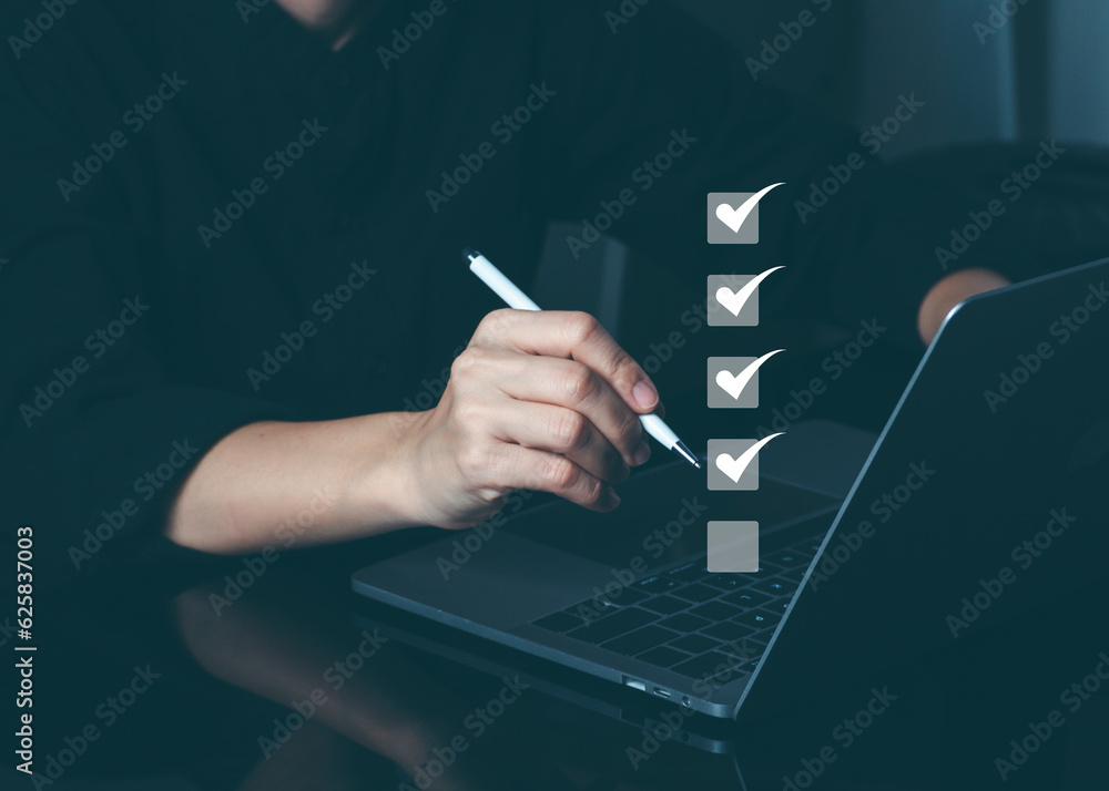 Foto de Businesspeople using laptop doing online checklist survey ...