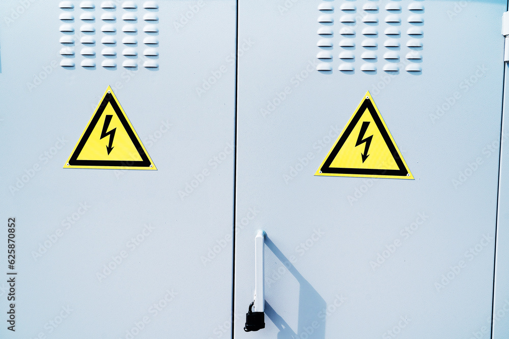 Metal door of the transformer box with symbols and signs for the ...