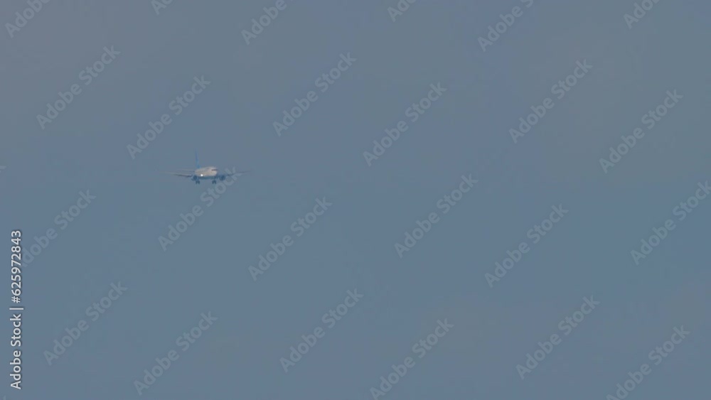 Airliner flies in the blue sky, panoramic view. Passenger jet plane ...
