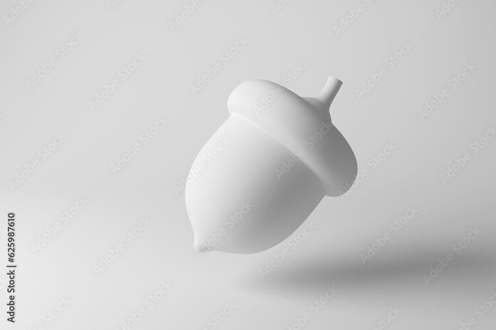 White acorn floating in mid air on white background in monochrome and ...