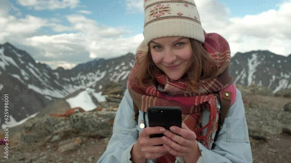 Young Woman using mobile phone in the autumn mountain. Female using ...