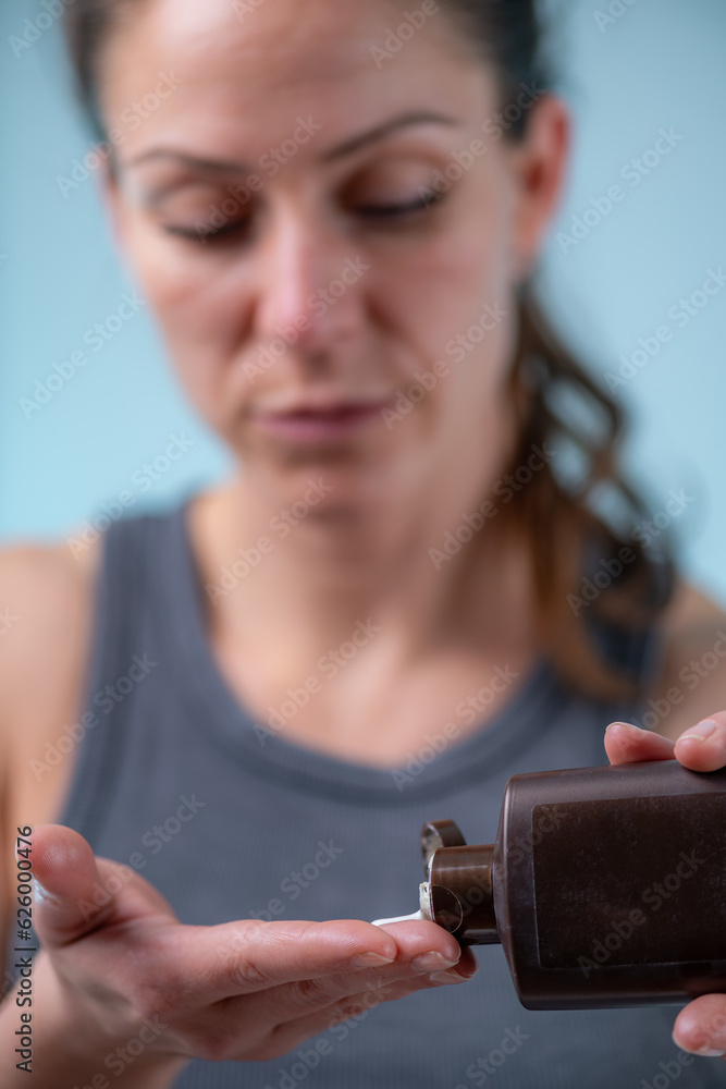 Foto de Woman Applies Sunscreen in Self-Care Routine. Woman takes care ...