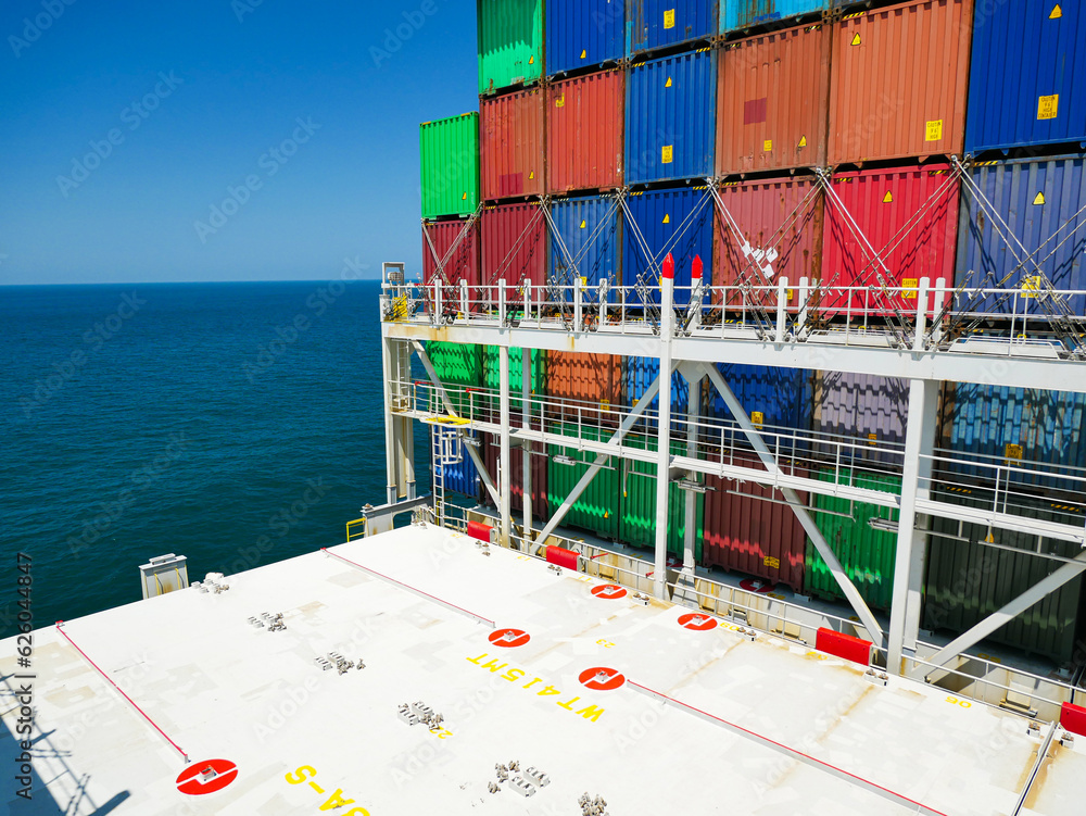 Different color containers loaded on ultra large container vessel and ...