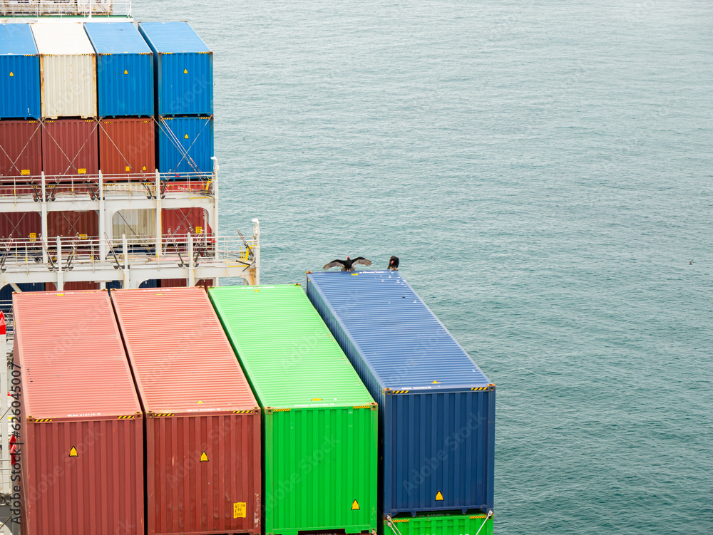 Different color containers loaded on ultra large container vessel and ...