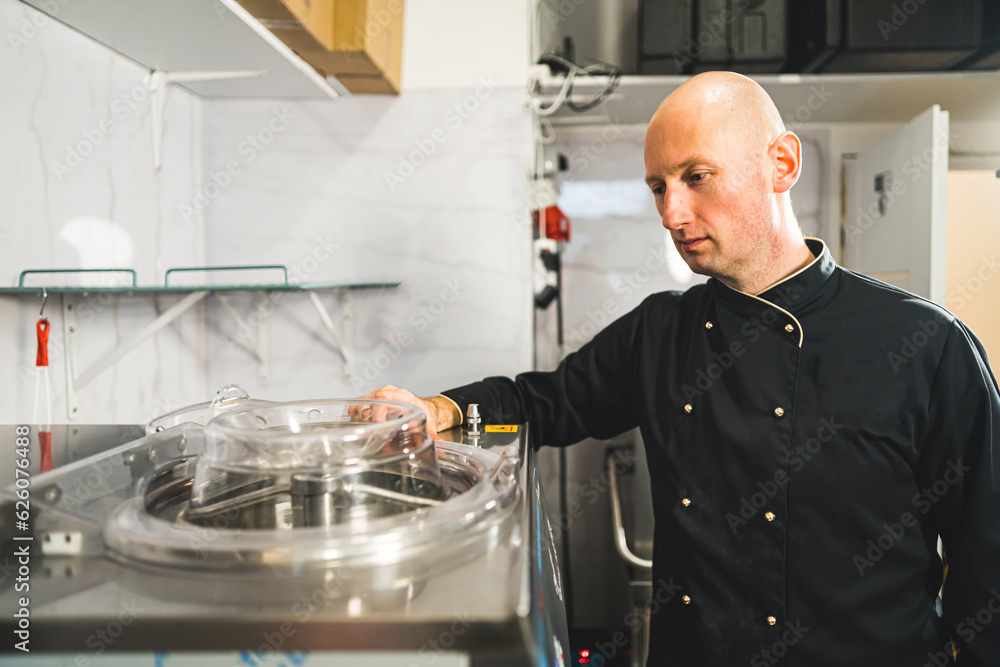 Professional chef supervising ice cream machine at work. Job ...