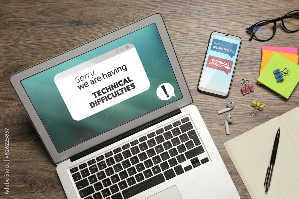 Laptop and smartphone with messages Sorry We Are Having Technical ...