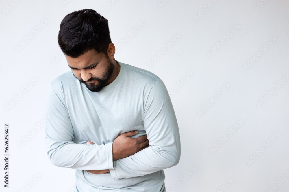 South asian Indian man being sick with stomachache concept image for ...