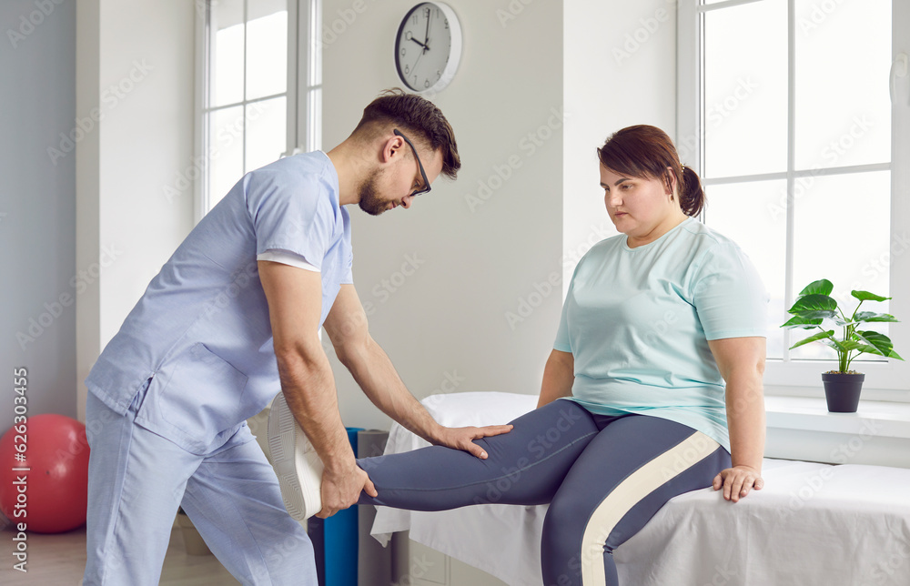 Young professional physiotherapist prepare overweight fat woman for gym ...