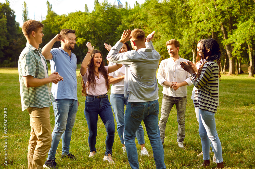 Large group of fun cool young best friends hanging out together in park ...