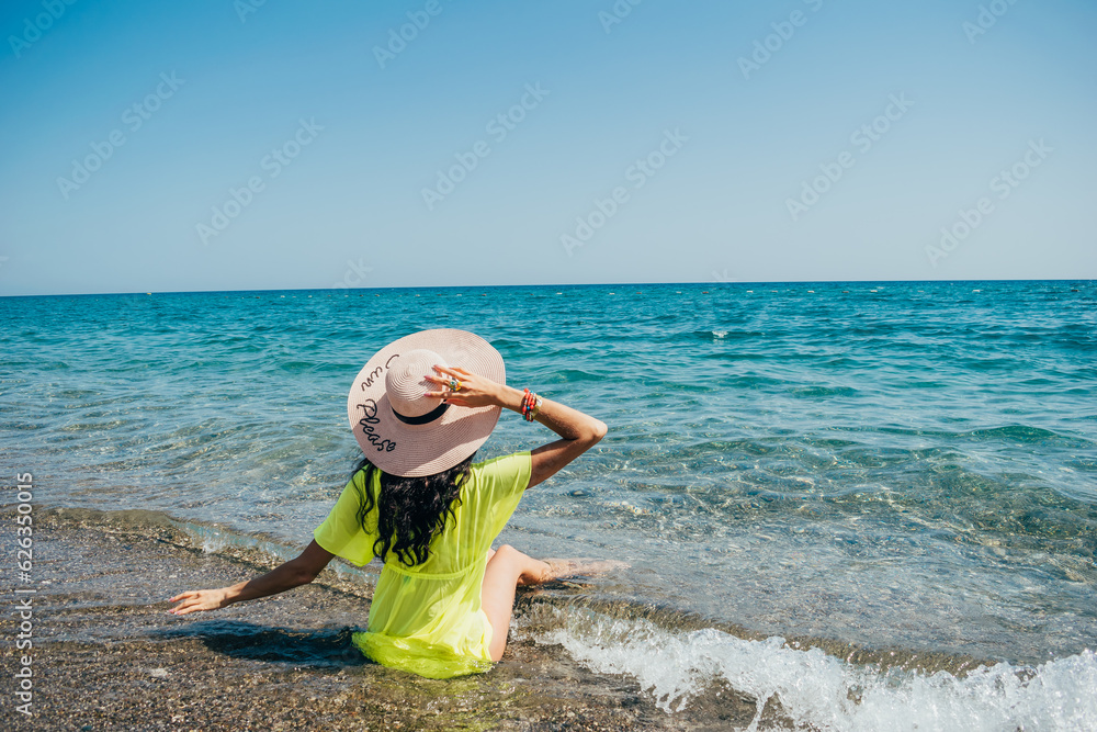 Girl in swimsuit on the beach. Tropics. Palms and sea, near the hotel ...