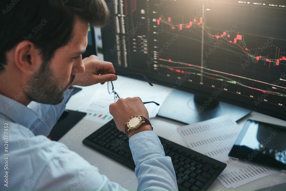 Time to trade. Bearded male trader looking at watch on his hand while ...
