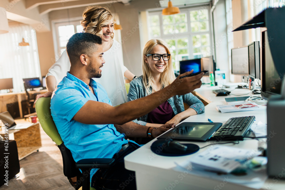 Young people working together on a project in a startup company office ...