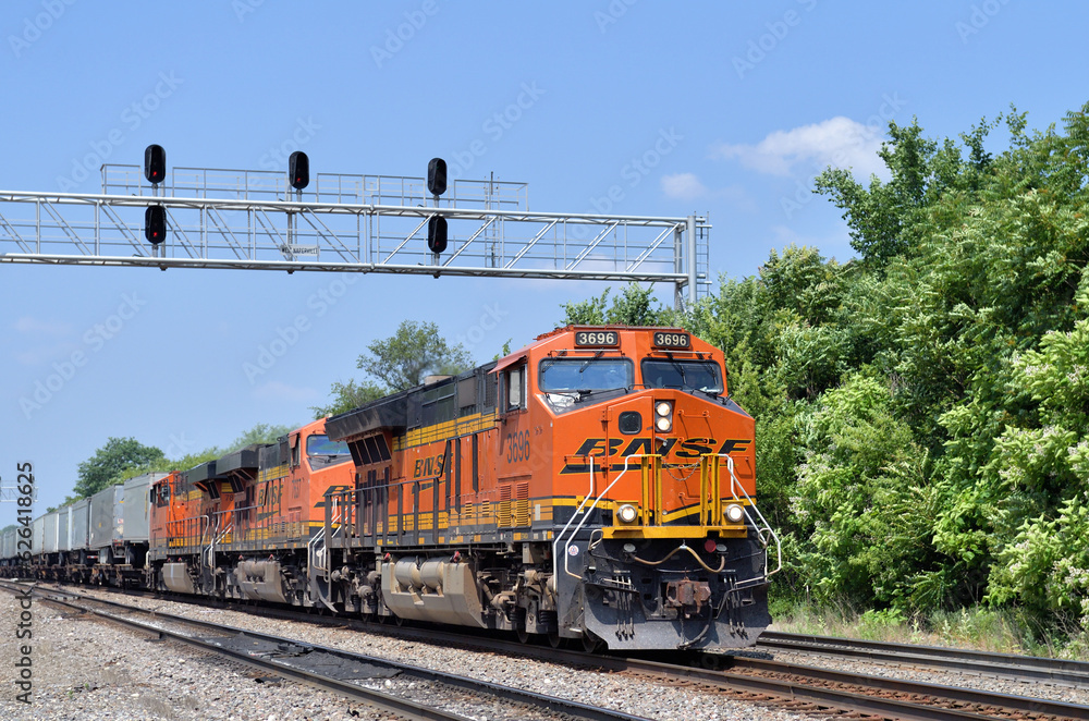 Burlington Northern Santa Fe locomotives lead an intermodal freight train through northeastern ...