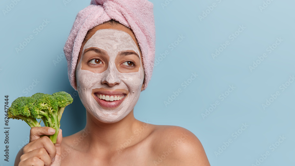 Beauty and wellness concept. Cheerful woman with towel on head indulges ...