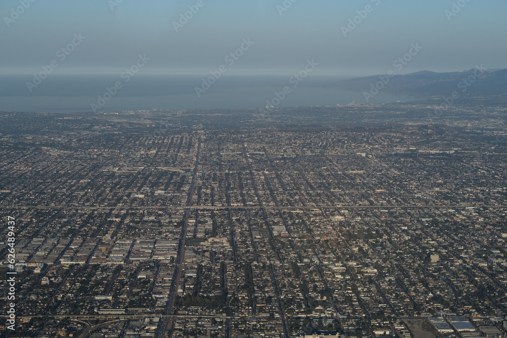 An aerial view over Los Angeles, looking towards the Pacific Ocean. The ...
