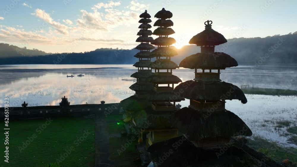 Beautiful traditional Bali temple on a foggy mountain lake at sunrise ...
