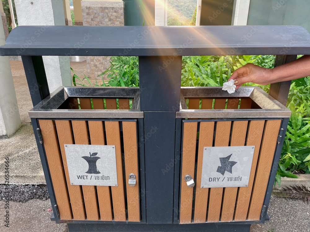 Asian old woman throwing tissues into the trash bin, Recycling bin ...