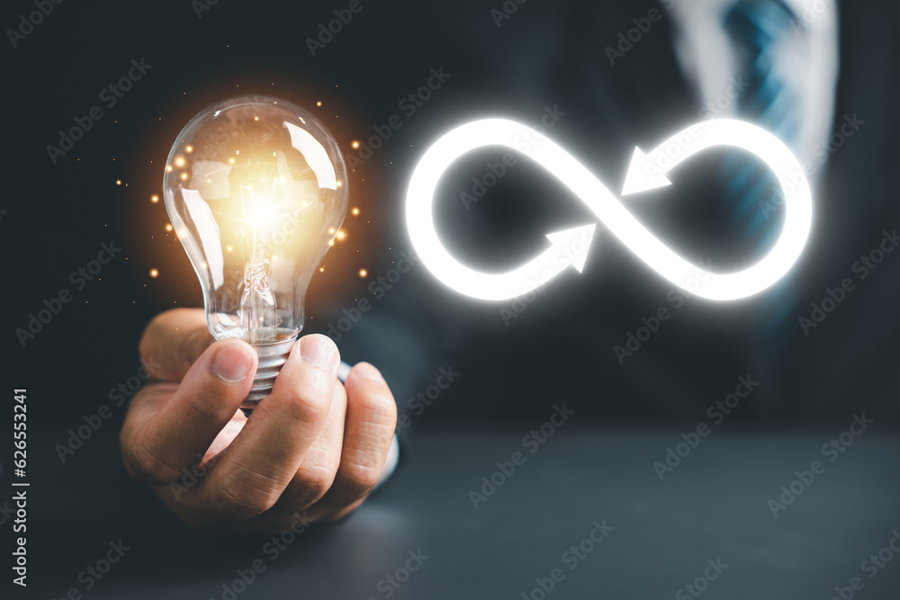 Man reveals light bulb with infinite symbol icon, illustrating creative ...